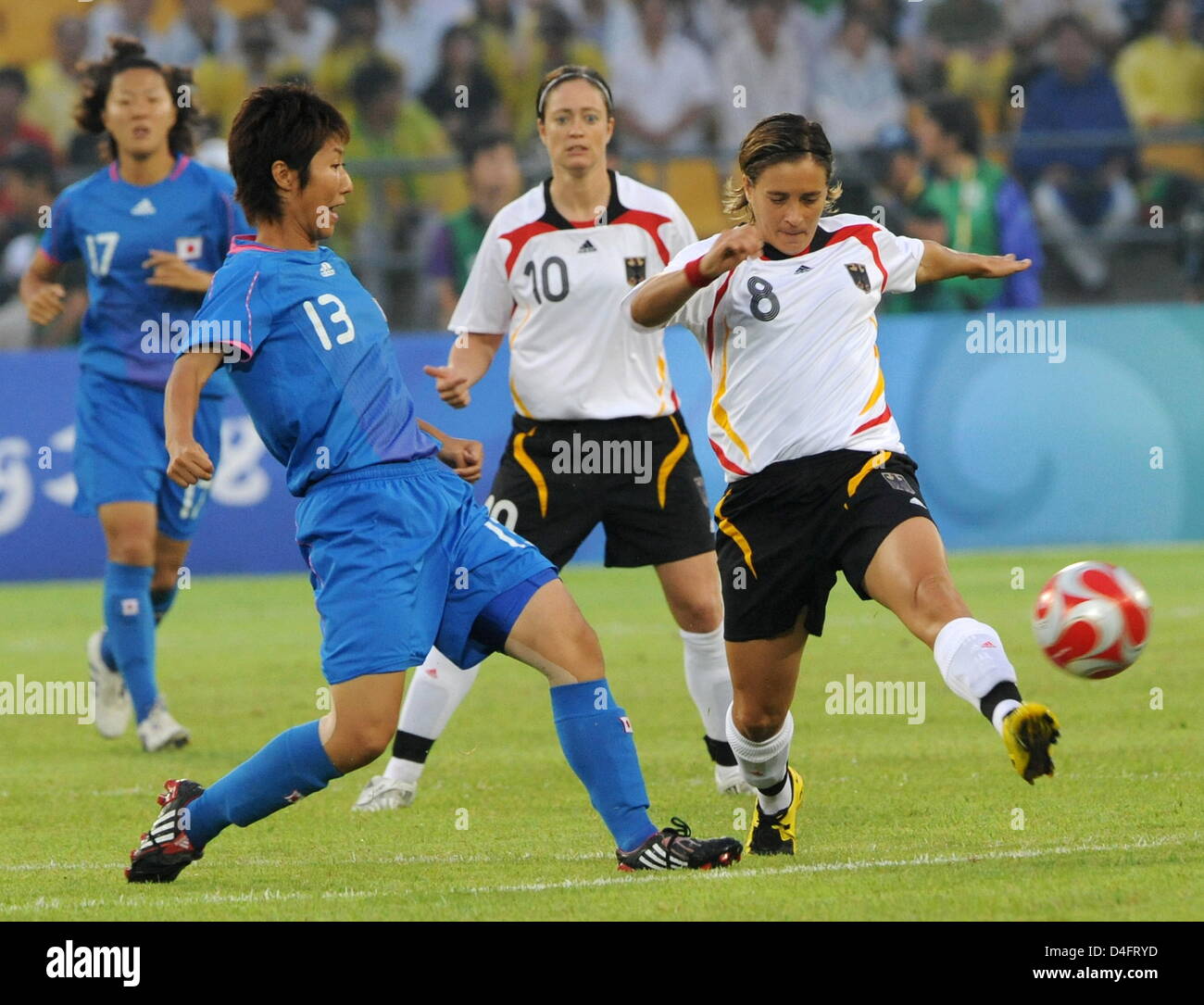 Sandra Smisek (r) and Renate Lingor of Germany vies with Yuki Nagasato ...