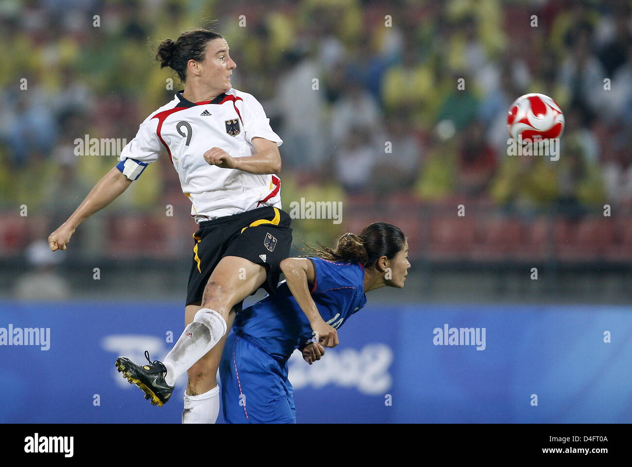 Birgit Prinz (L) of Germany vies with Shinobu Ohno (R) of Japan during ...