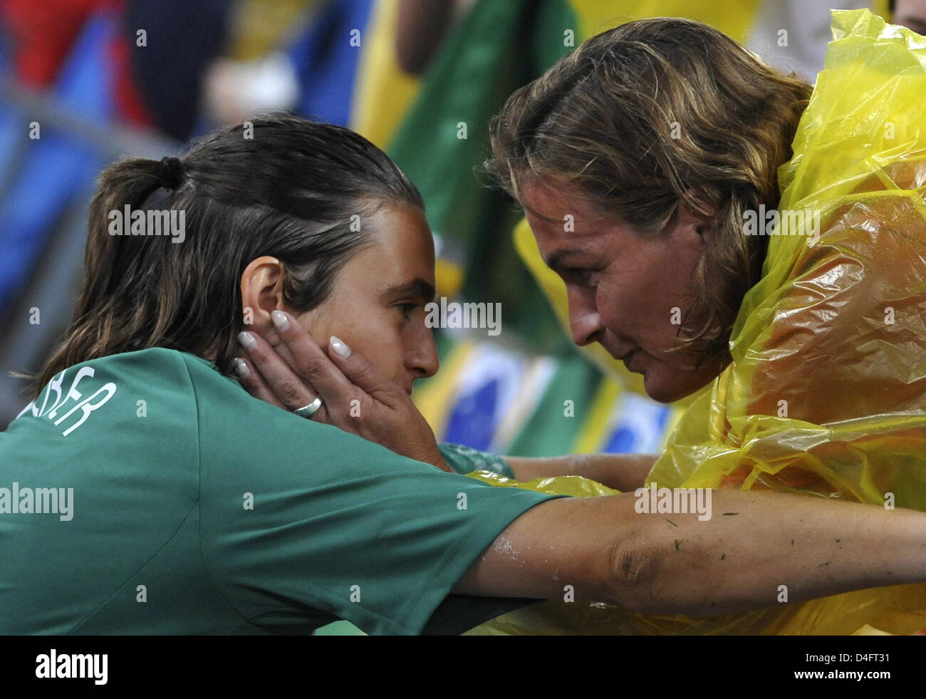 German goalkeeper Nadine Angerer (L) gets caresses by her mother Petra ...
