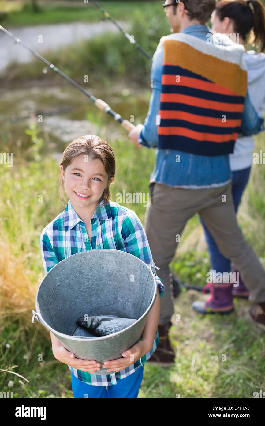 Girl showing off fishing catch Stock Photo - Alamy