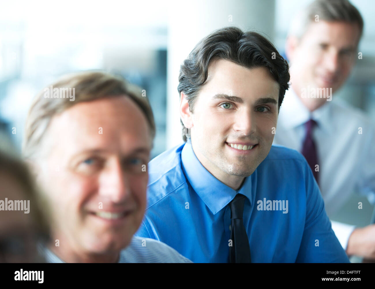 Businessmen smiling in meeting Stock Photo - Alamy