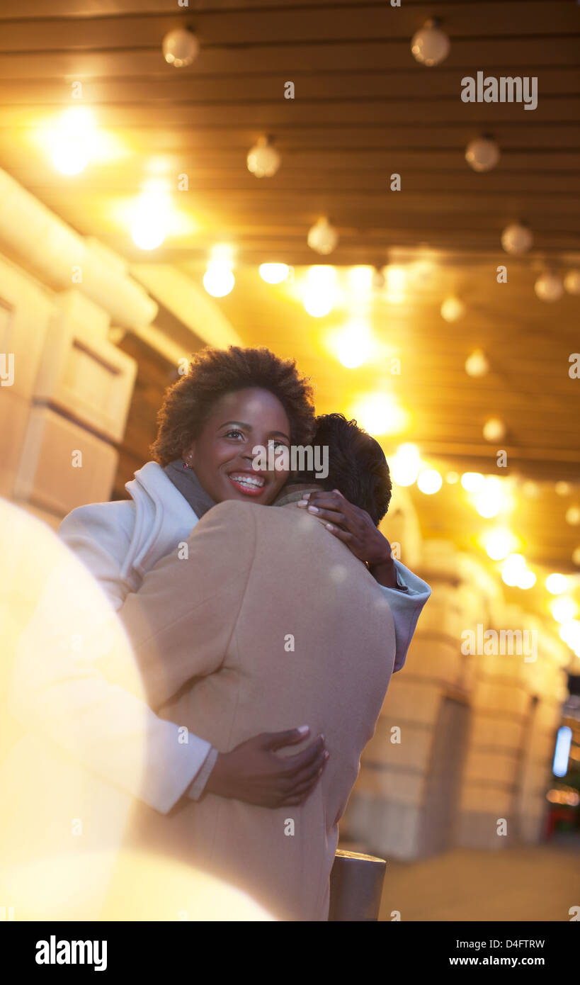 Couple hugging on city street Stock Photo - Alamy