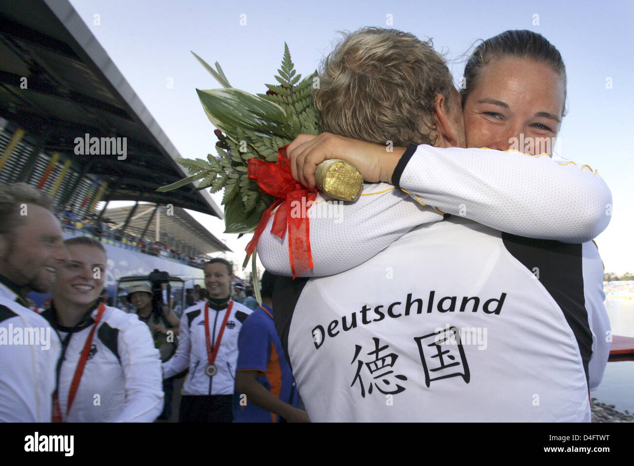 Conny Wassmuth (R) of Germany embraces compatriot Martin Hollstein (2nd ...