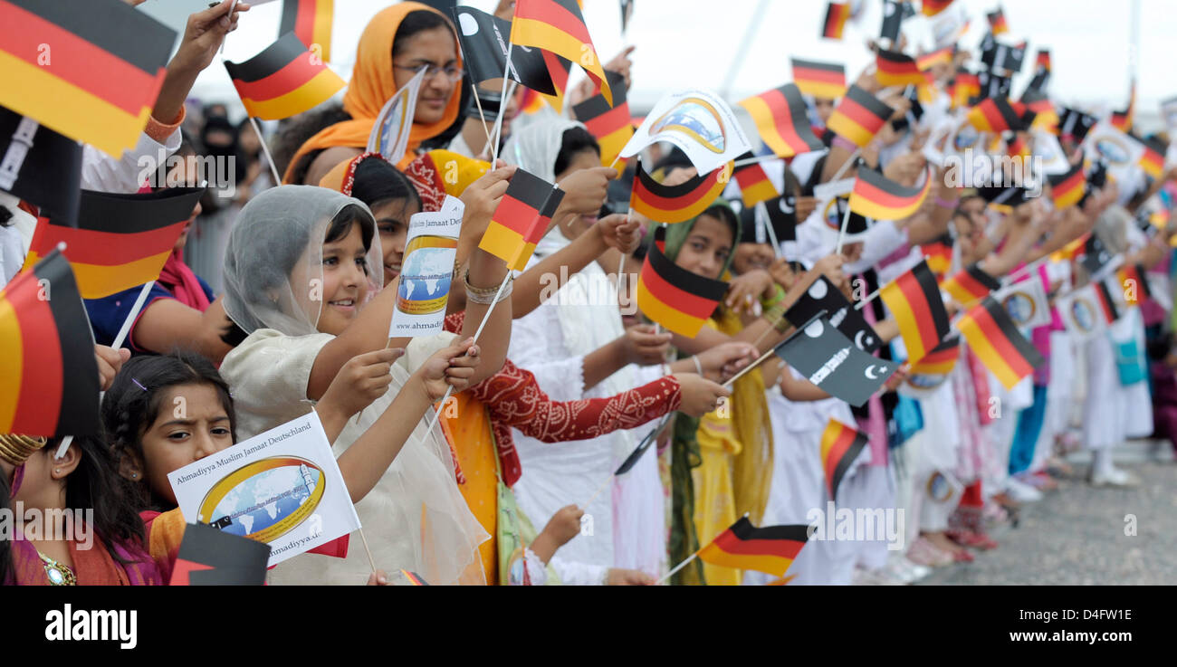 Girls of Ahmadiyya Muslim Community wave flags during a celebration in ...