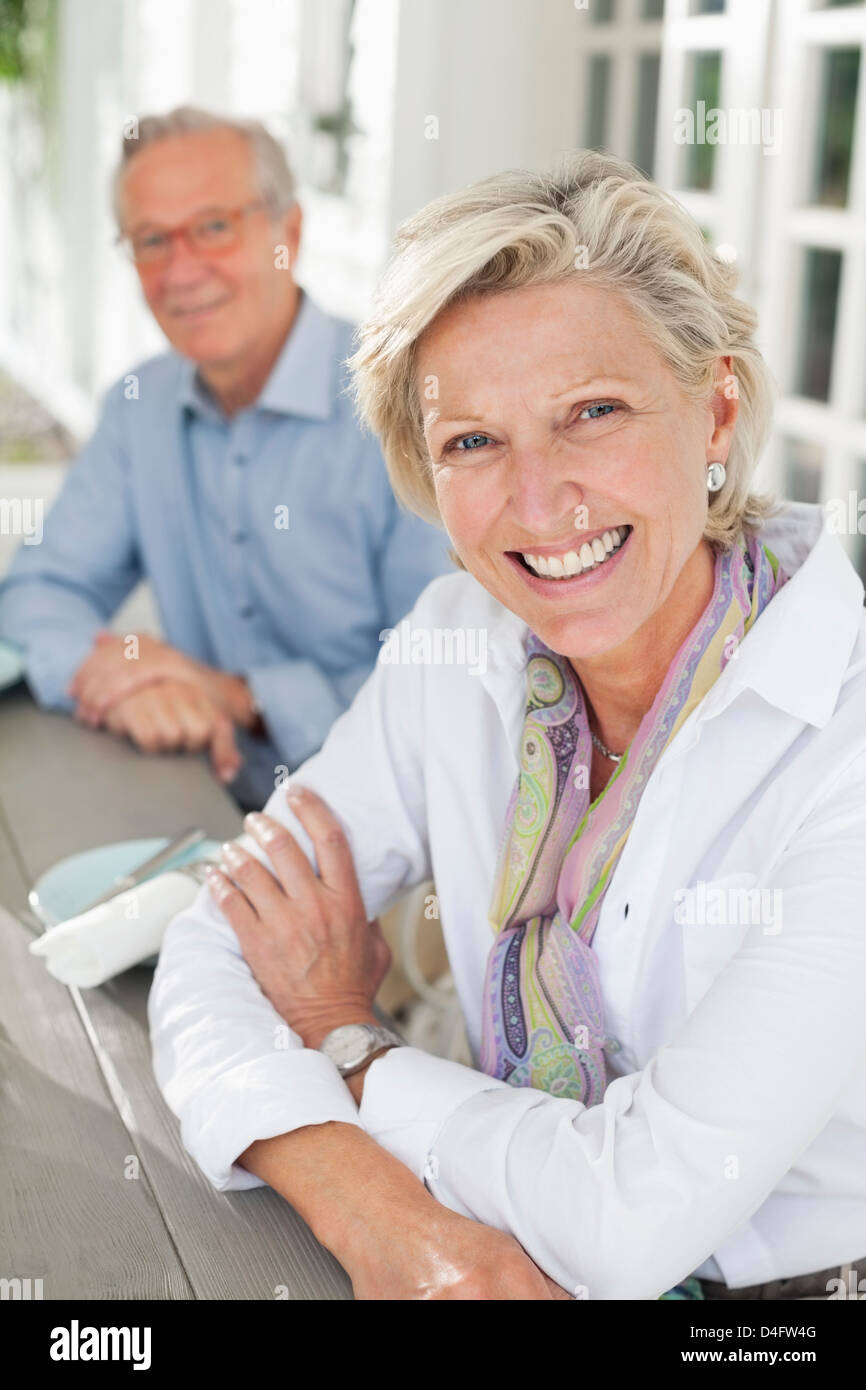 Couple smiling together at table Stock Photo - Alamy