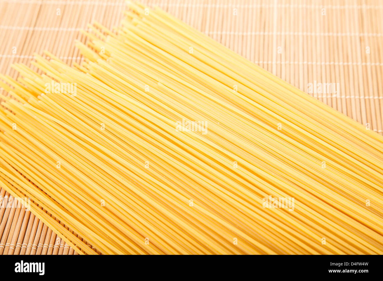 Spaghetti Pasta Noodles on a bamboo mat Stock Photo - Alamy