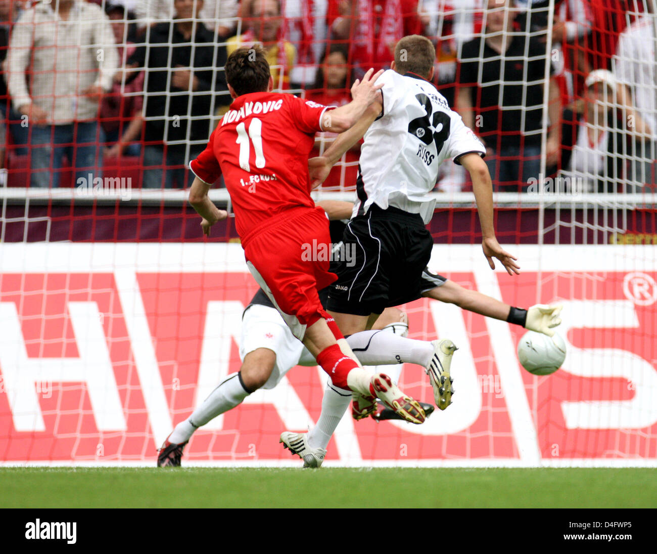 Cologne's Milivoje Novakovic (L) scores the 1-0 lead goal next to ...