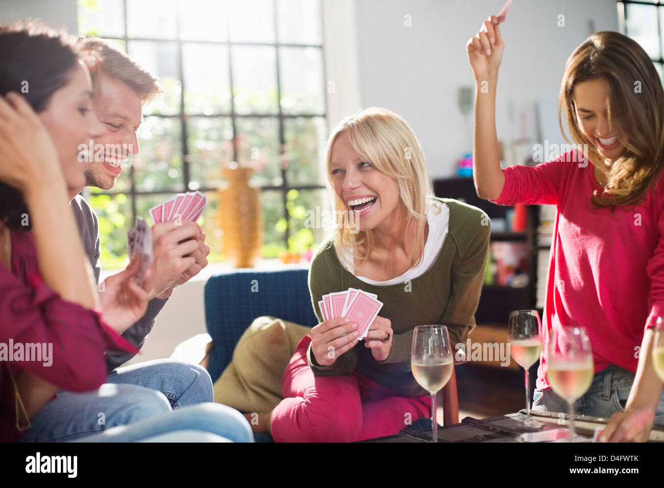 Friends playing card game in living room Stock Photo - Alamy
