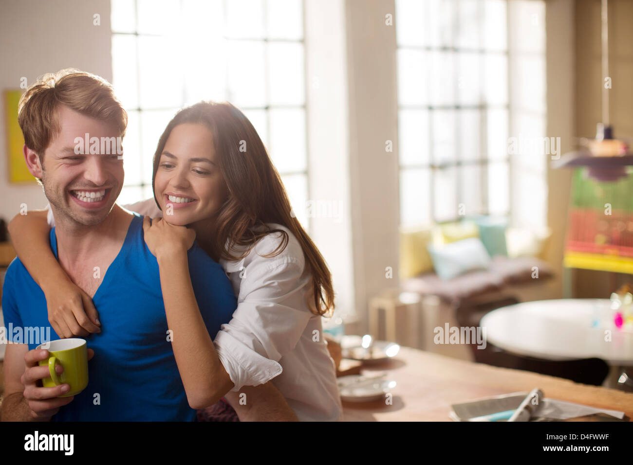 Couple hugging in kitchen Stock Photo - Alamy