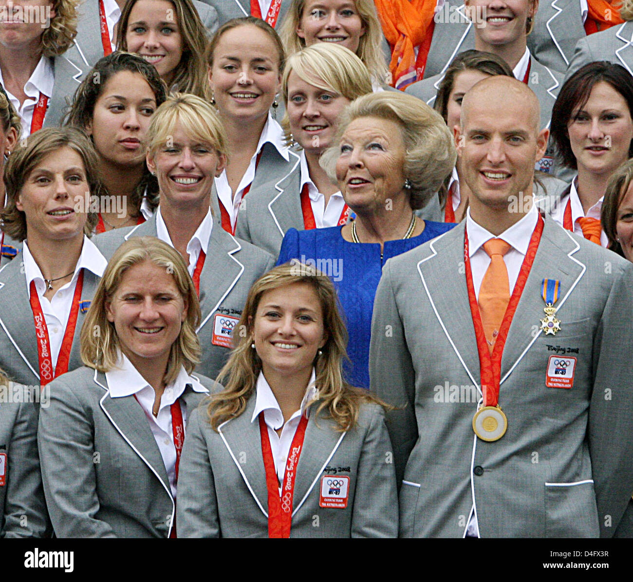 Dutch Queen Beatrix (C) poses for a group picture with athletes as she ...