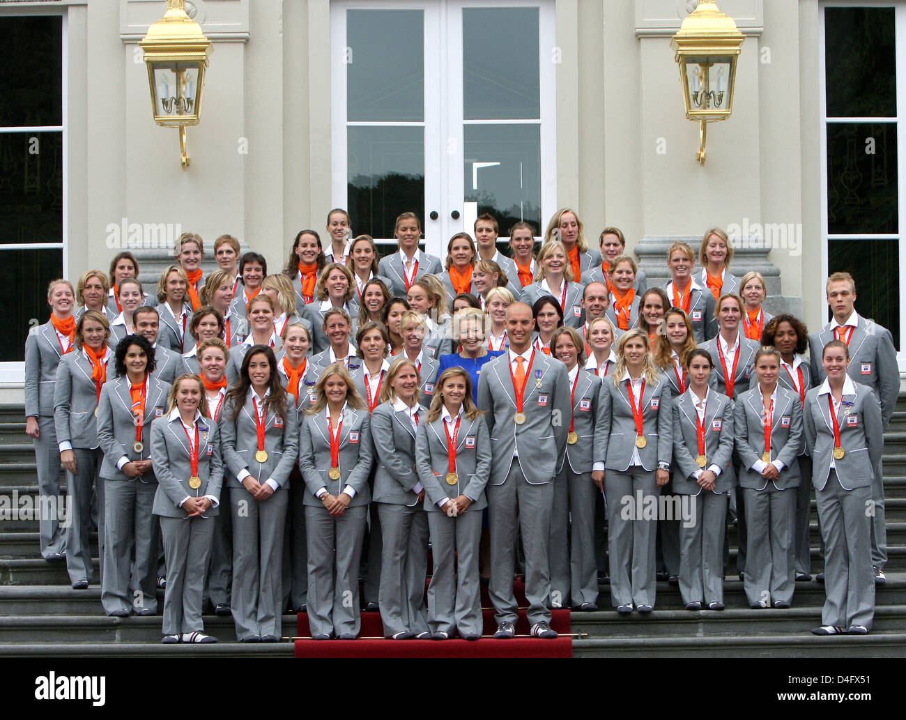 Dutch Queen Beatrix (C) poses for a group photo with athletes as she ...