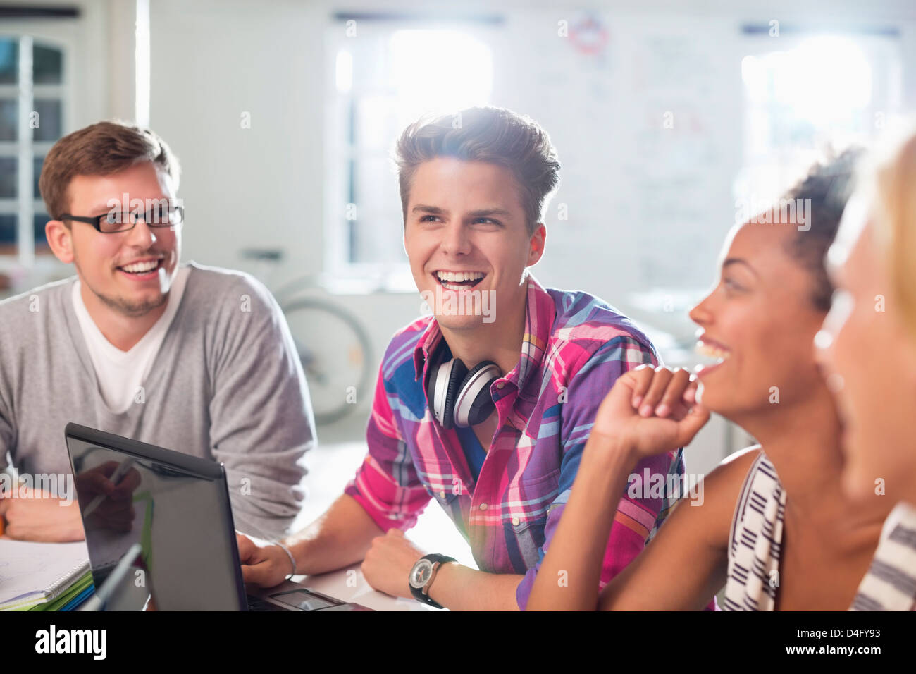 Friends talking at desk Stock Photo - Alamy