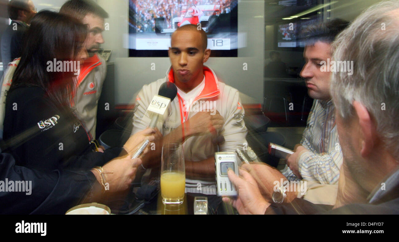 British Formula One driver Lewis Hamilton (C) of McLaren Mercedes gives ...