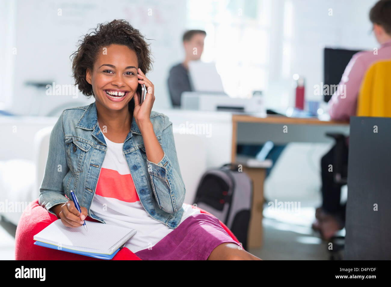 Young woman in office using telephone hi-res stock photography and ...