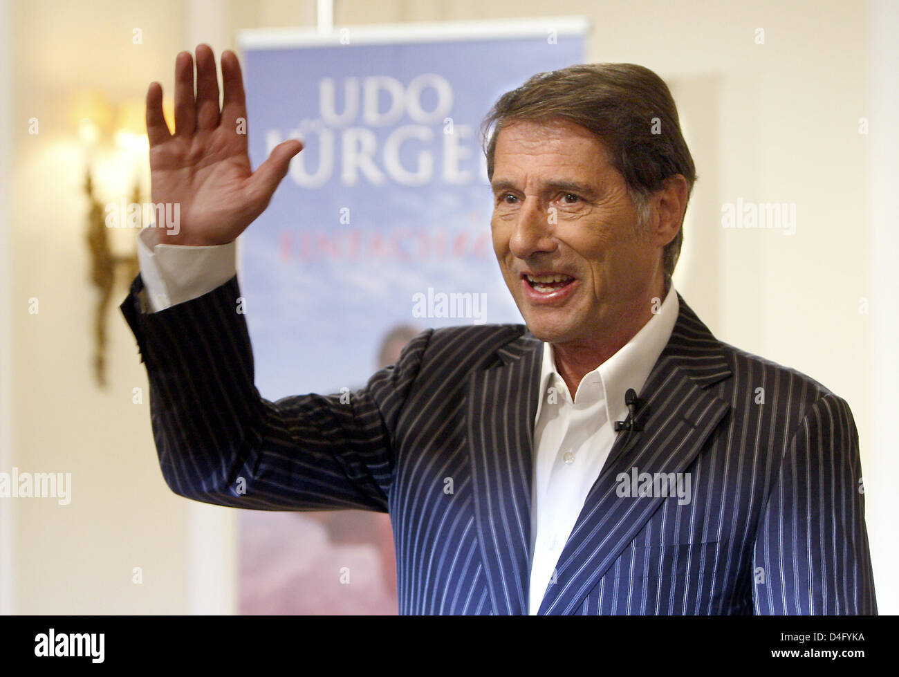 Austrian musician Udo Juergens poses with the Golden Record for his ...