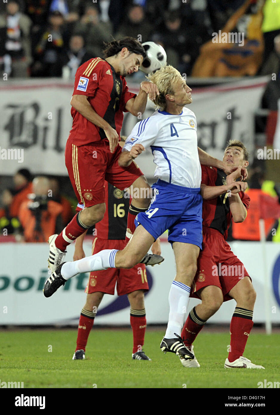 Germany's Serdar Tasci (L) and Finland's Sami Hyypiae (R) play a header ...