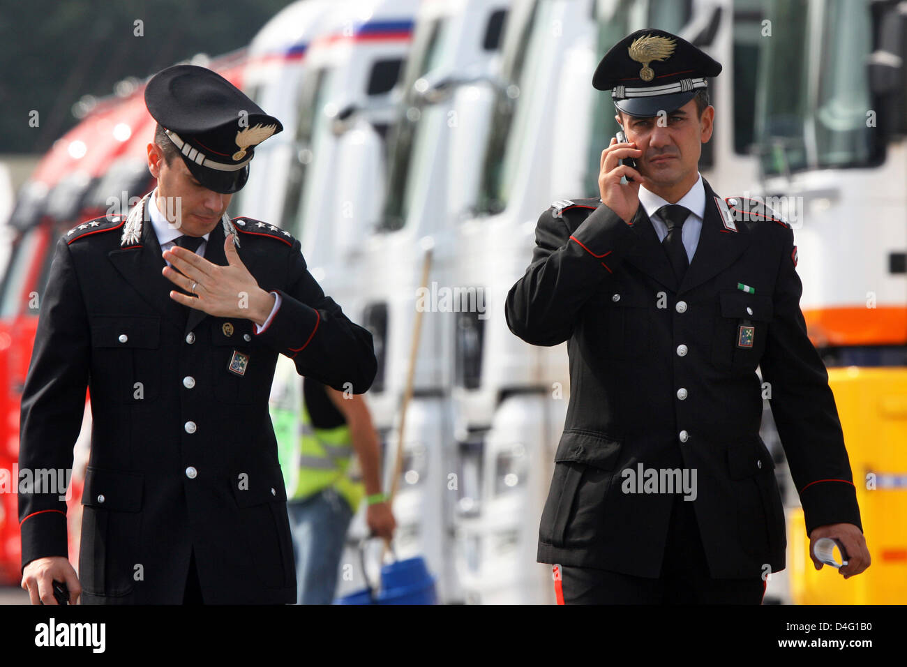 Two Carabinieri officers walk through the paddock of Autodromo ...