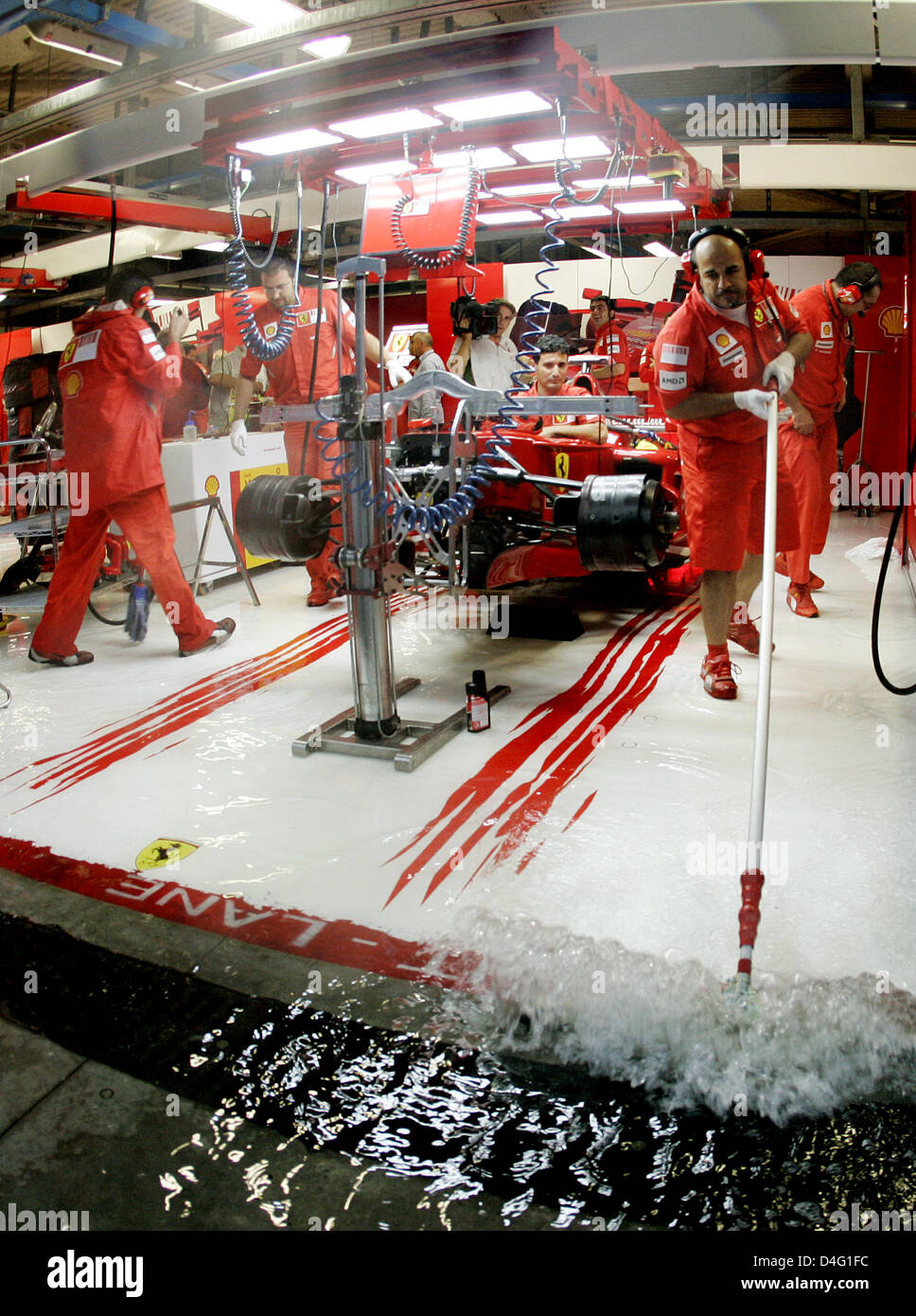 The garage of Scuderia Ferrari is flooded after heavy rainfalls during ...