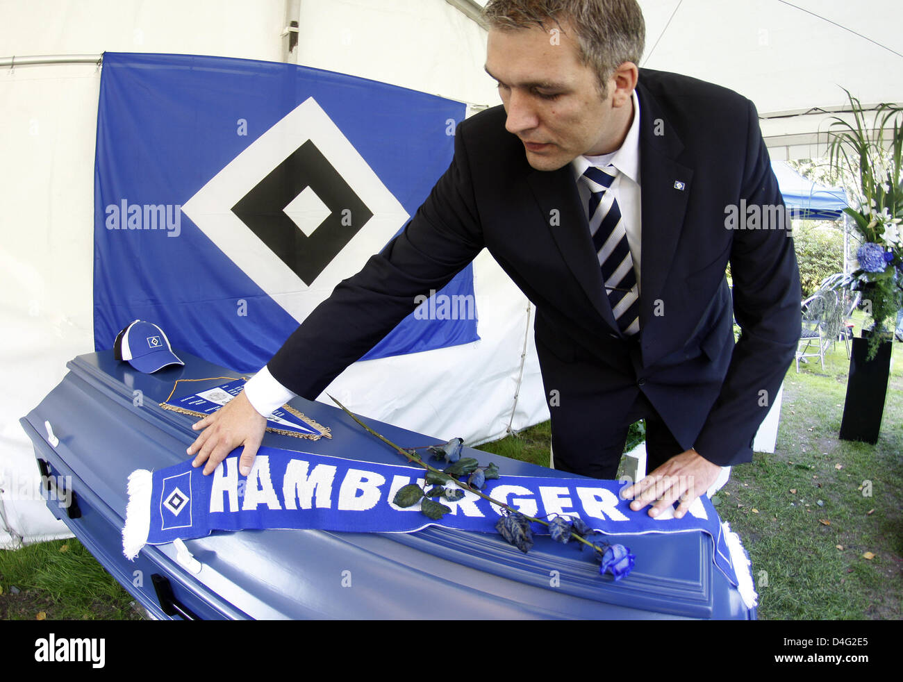 Mortician Christian Wengler puts a soccer scarf of Bundesliga club ...