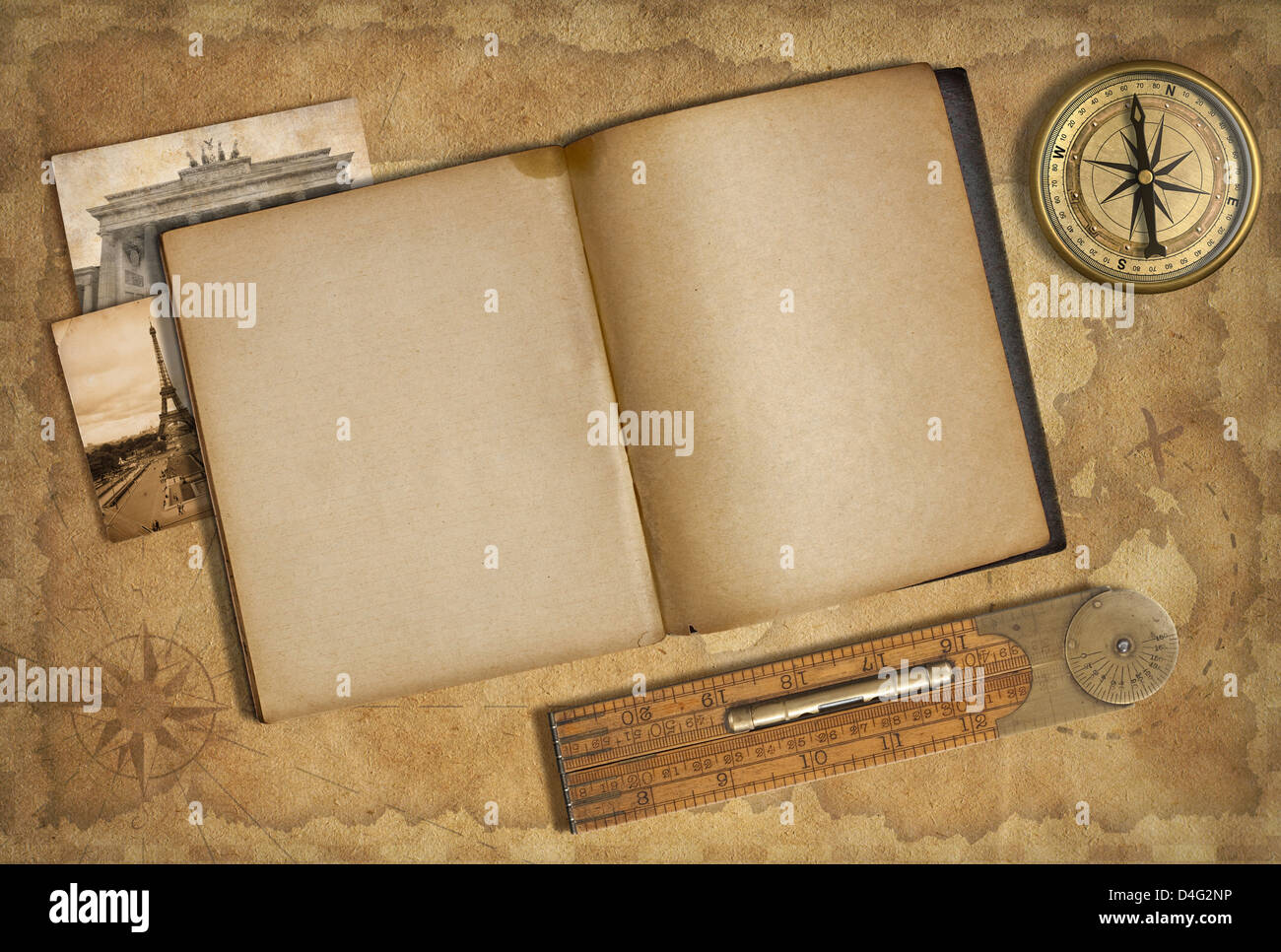 Open diary over old treasure map with compass Stock Photo - Alamy