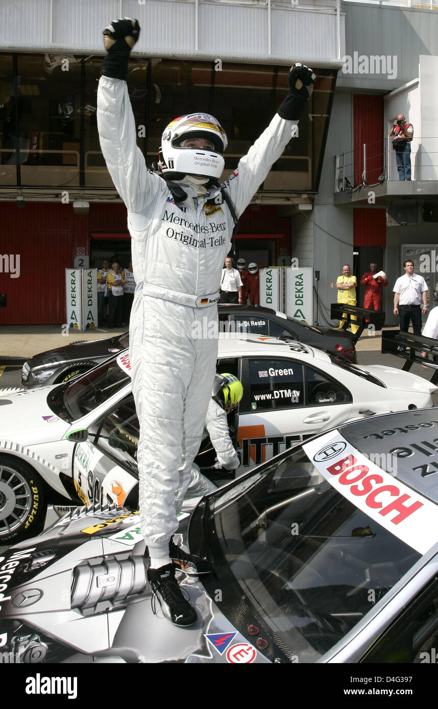 German race driver Bernd Schneider cheers after clocking the fastest ...