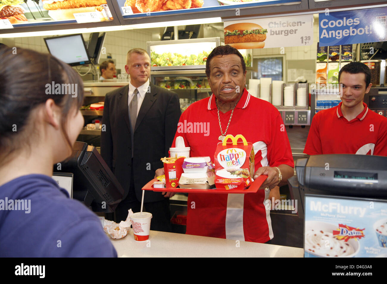Joe Jackson (C), father of musician Michael Jackson, sells burgers in a ...