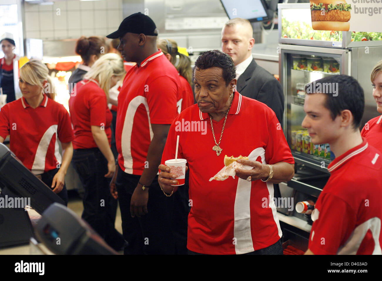 Joe Jackson (C), father of musician Michael Jackson, sells burgers in a ...