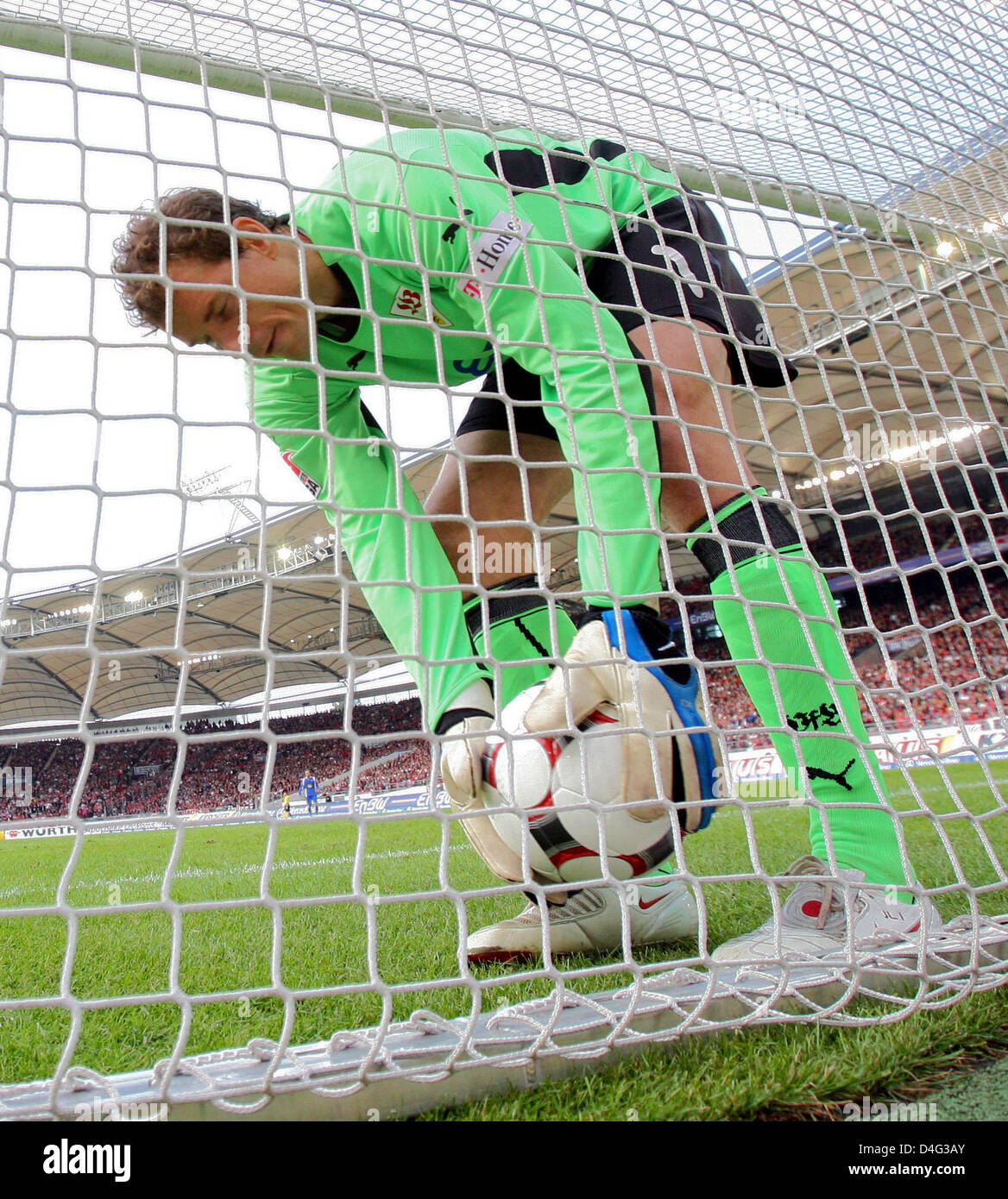 Stuttgart's goalkeeper Jens Lehmann picks up a ball from his goal ...