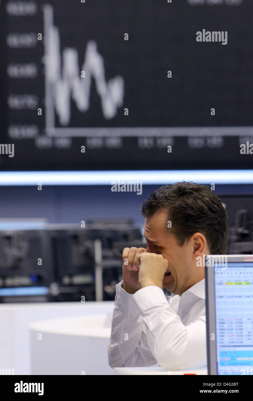 An equity trader wipes his eyes on the dealing floor of the stock ...