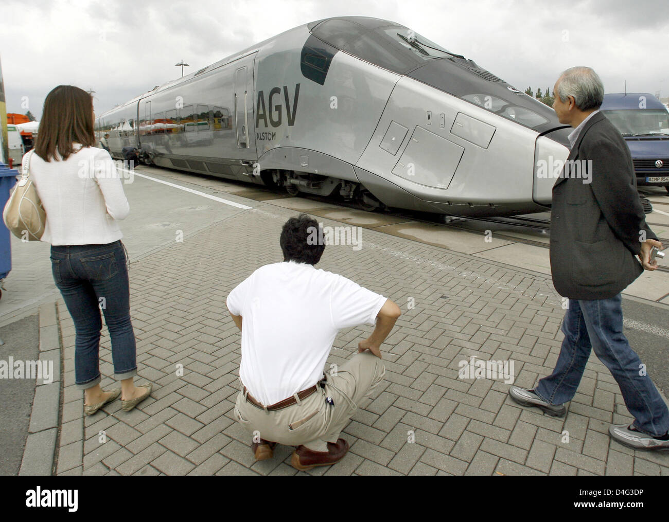 Interessted professional visitors watch the new French high-speed train ...