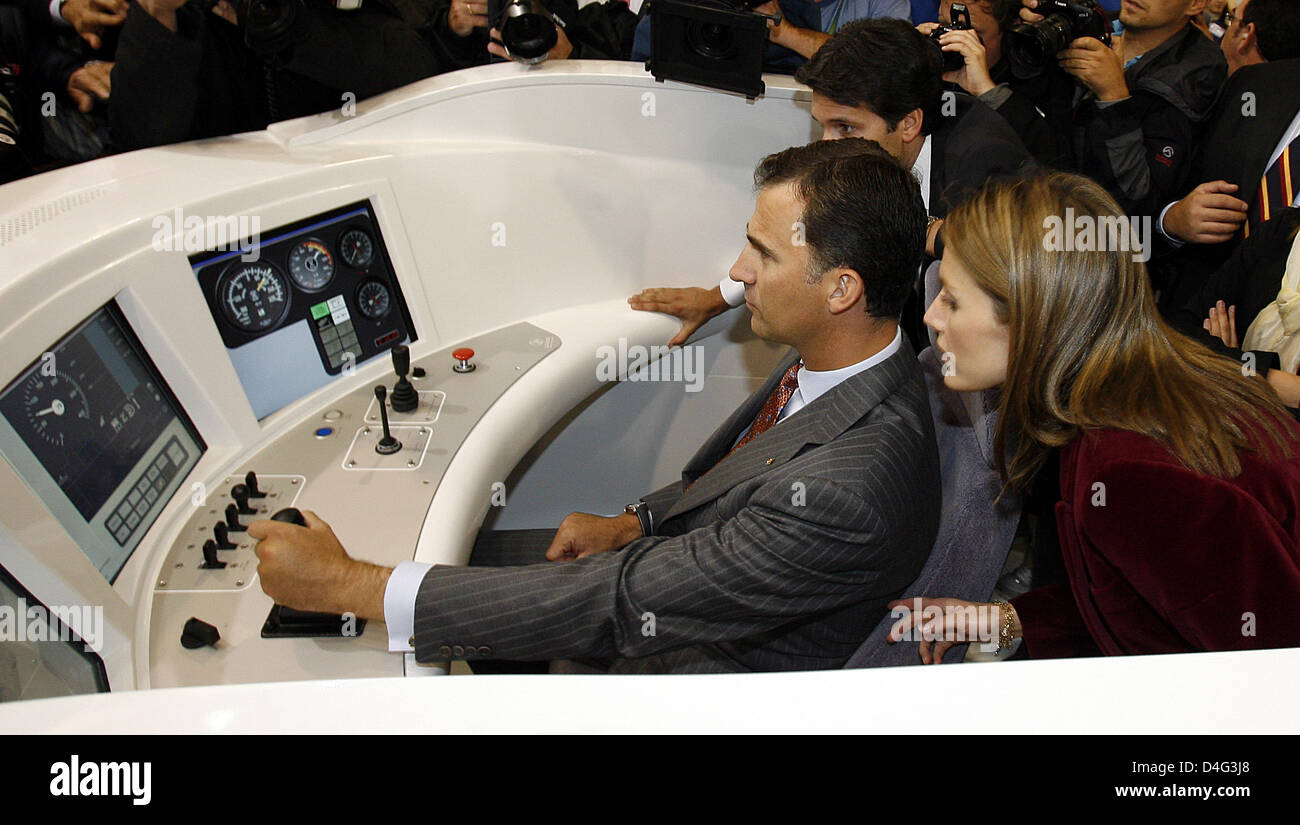 Spanish Crown Prince Felipe (L) sits in a train simulator of Spanish ...