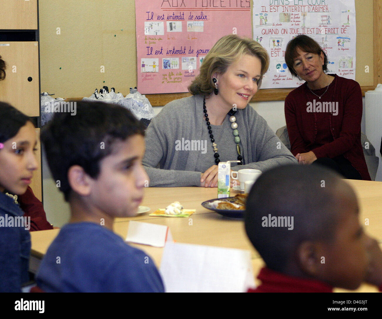 Princess Mathilde of Belgium (C) speaks to children during her visit at ...