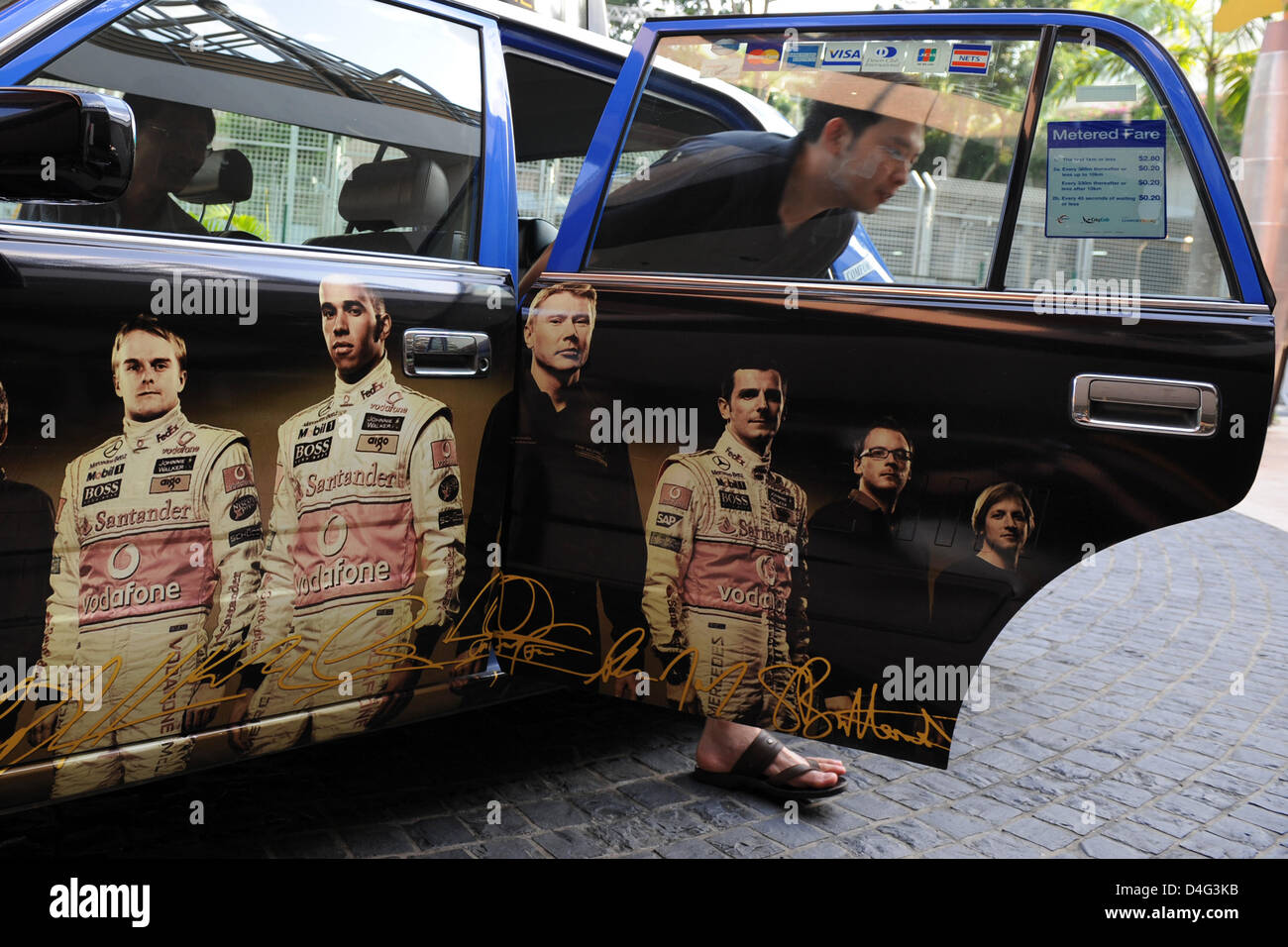 A man gets out of a taxi promoting the Formula 1 Singapore Grand Prix ...