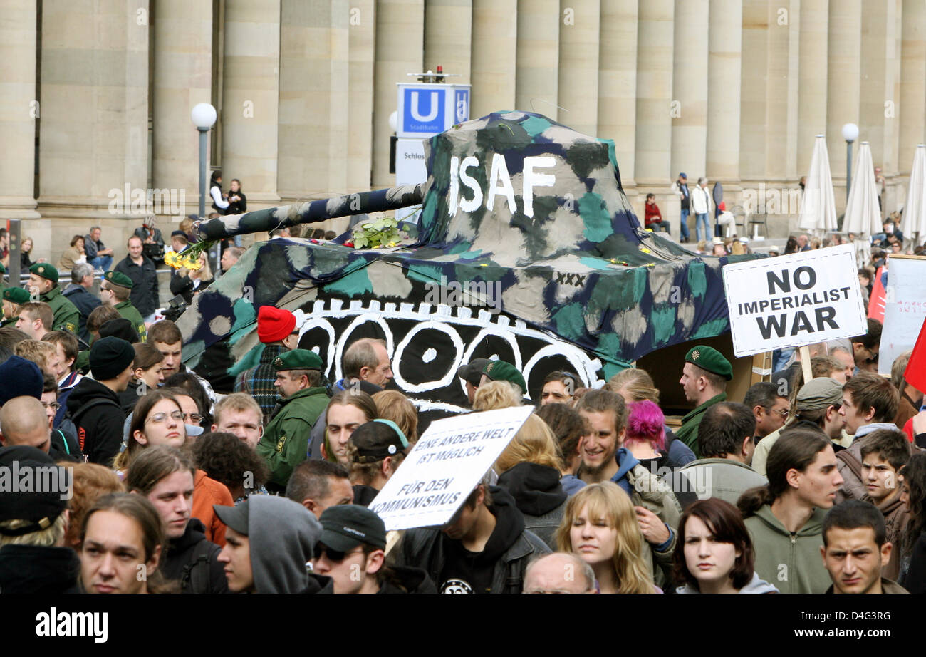 A replicated tank made from wood and cloth is carried by participators ...