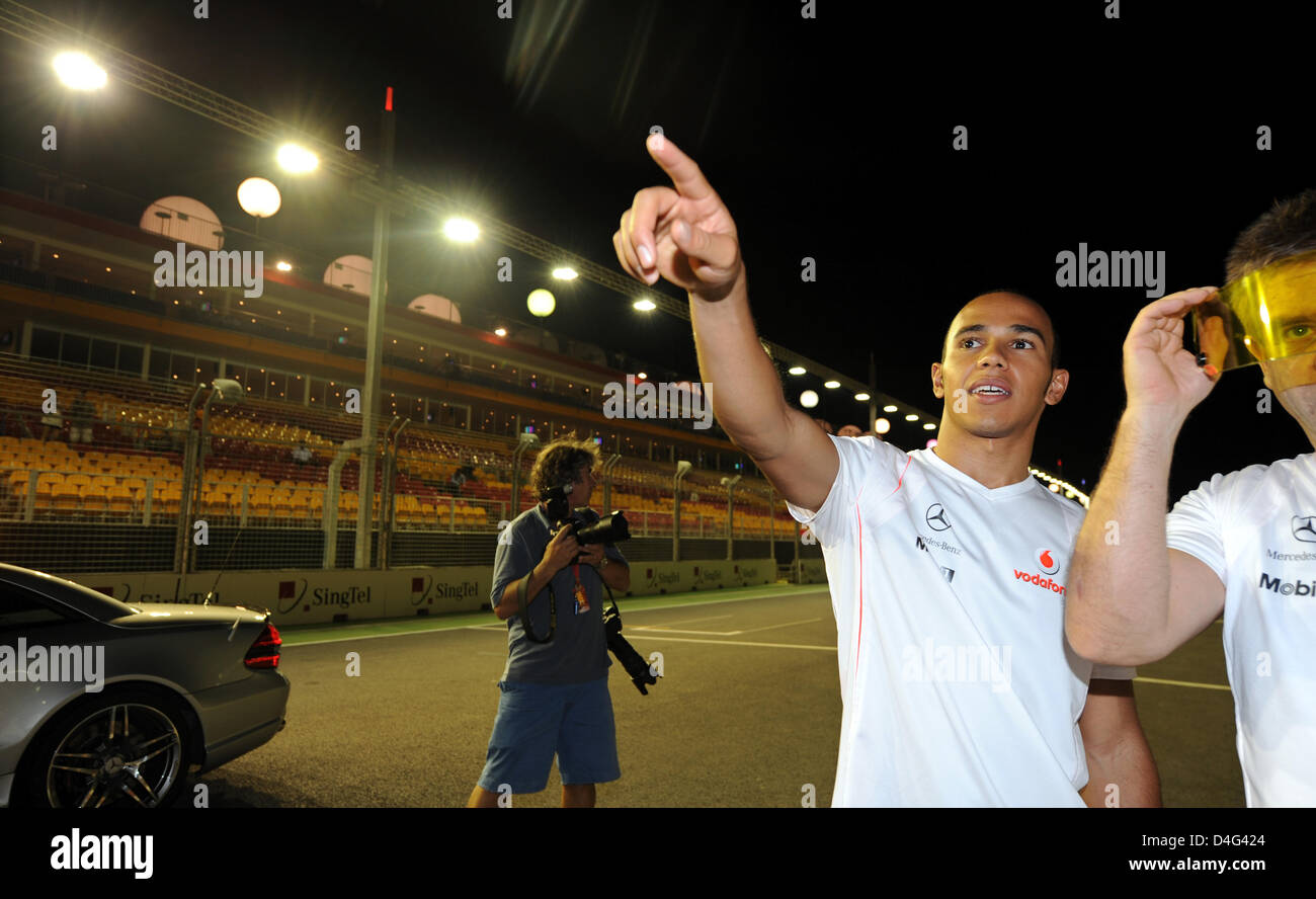 British Formula One driver Lewis Hamilton (C) of McLaren Mercedes talks ...