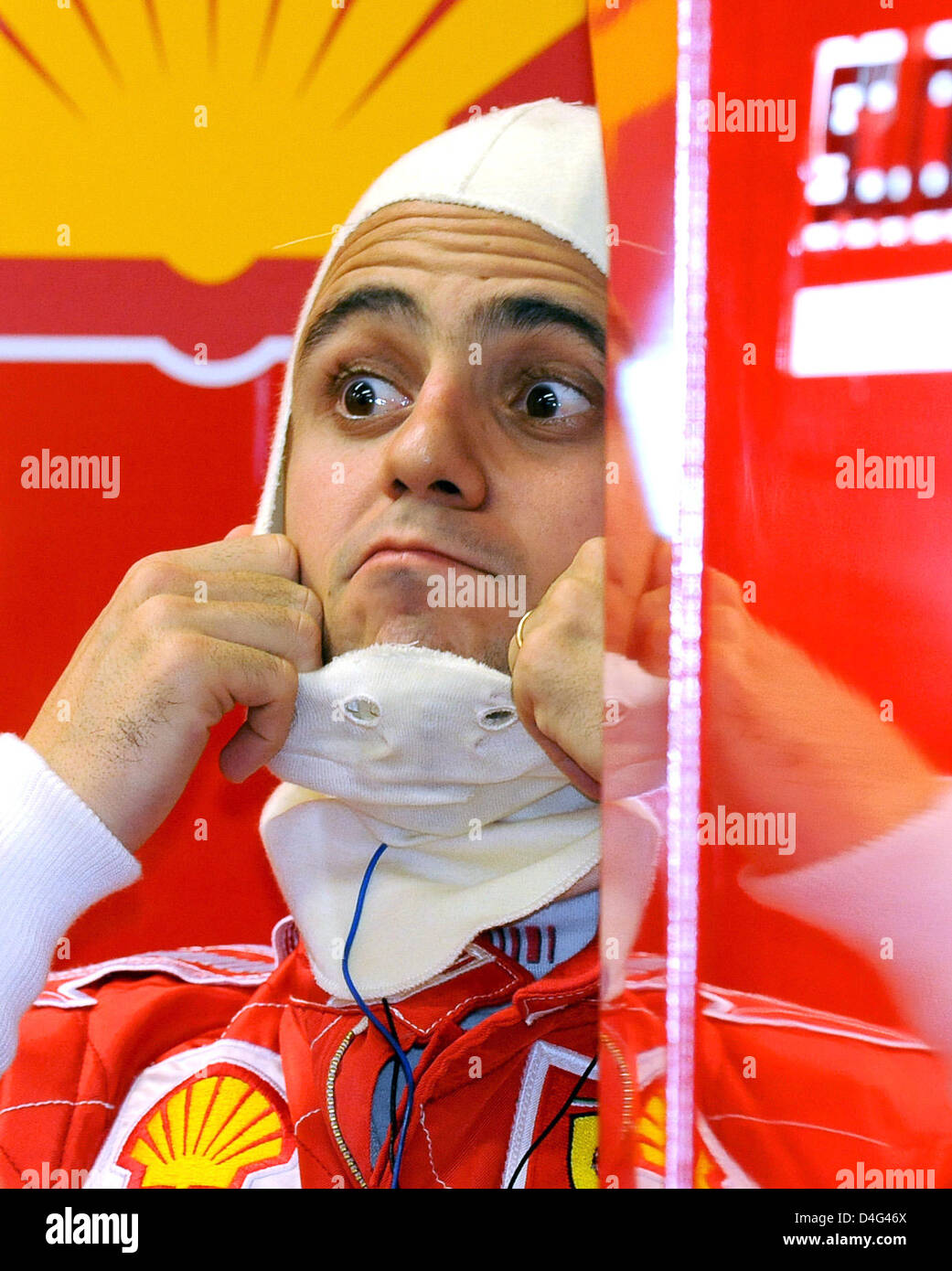 Brazilian Formula One driver Felipe Massa of Scuderia Ferrari puts on ...