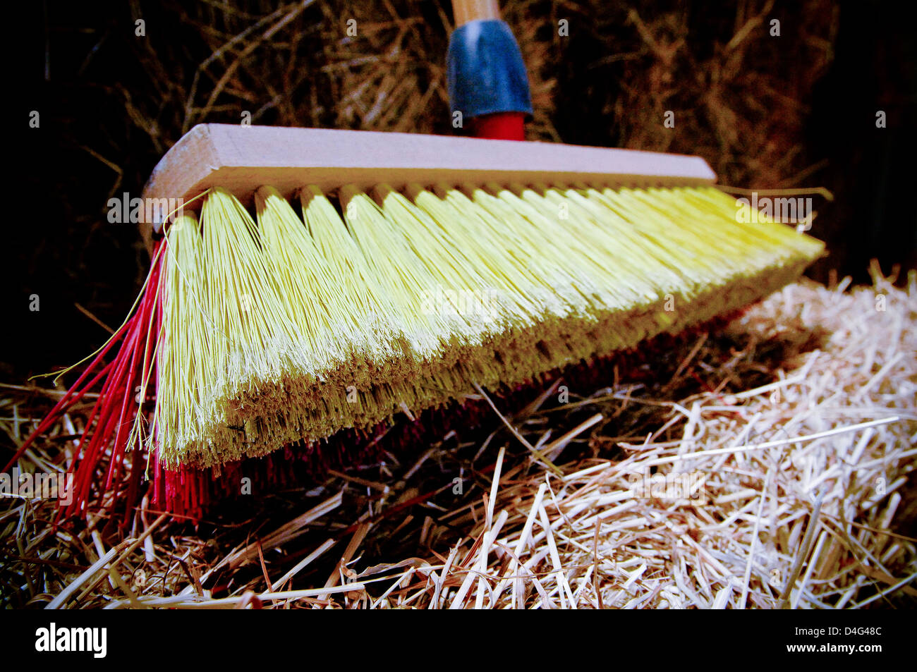 A sweeping brush rests beside some stacked hay bales Stock Photo - Alamy