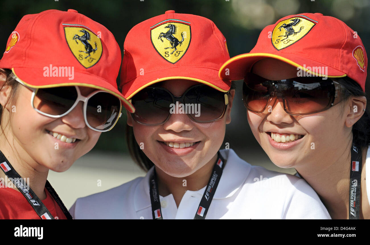 Female Ferrari fans smile to the camera at the paddock of Marina bay ...