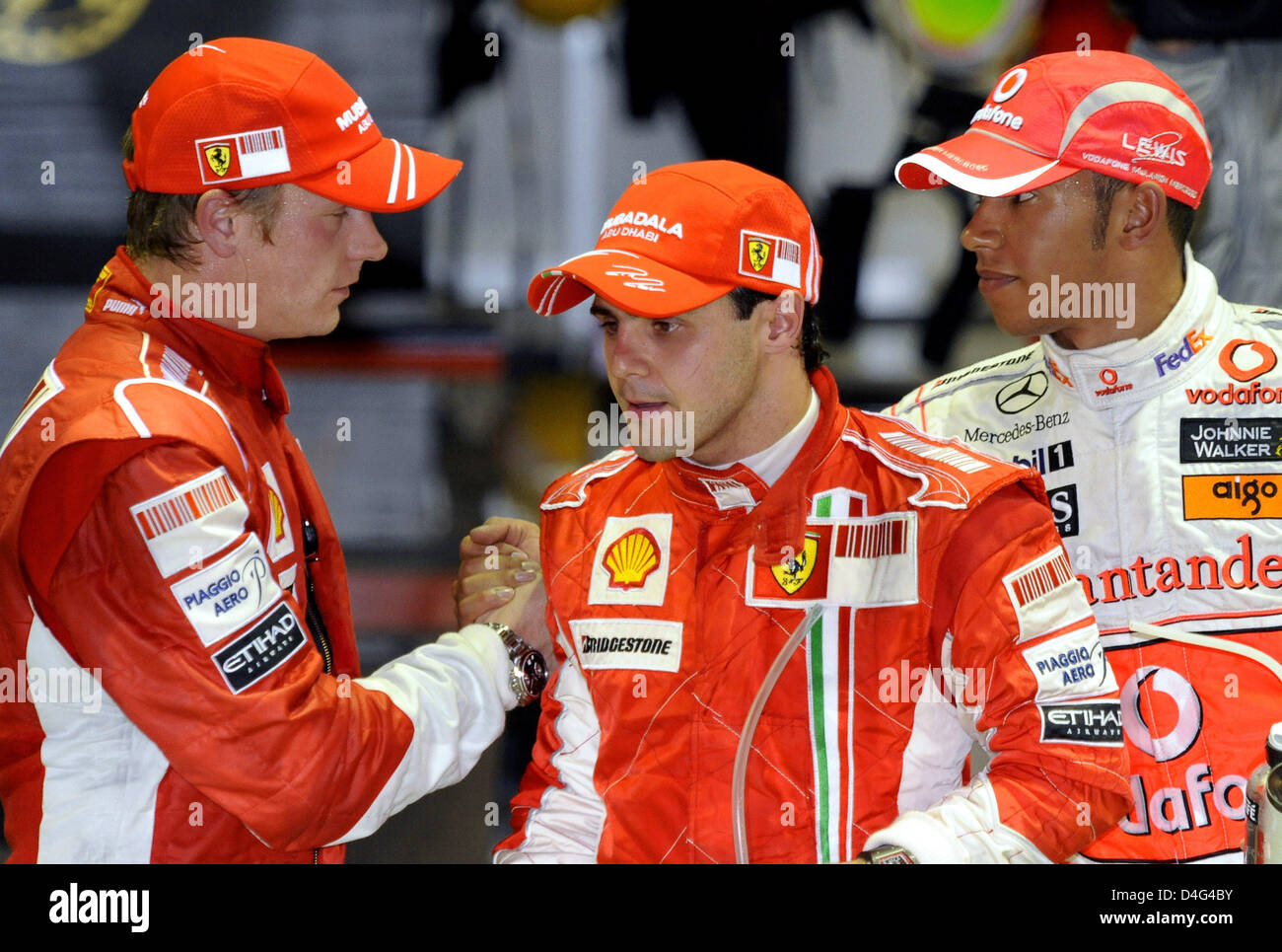 Brazilian Formula One driver Felipe Massa (C) of Ferrari reacts after ...