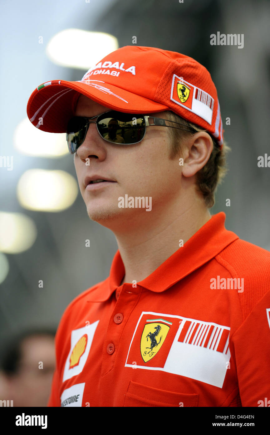 Finnish Formula One driver Kimi Raikkonen of Ferrari walks to the ...