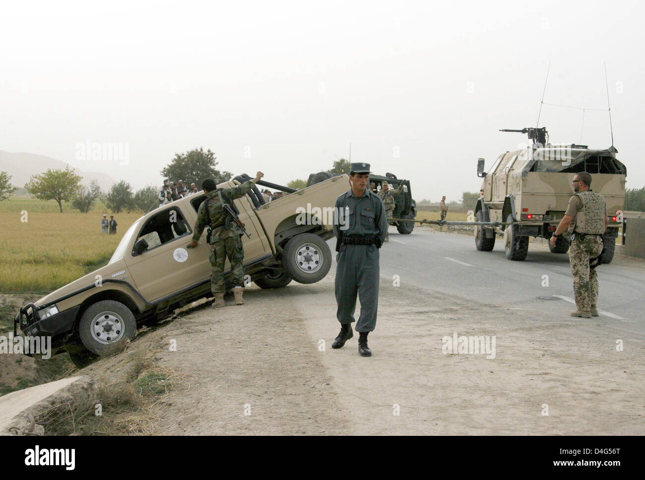 ISAF soldiers of German Bundeswehr retrieve a vehicle of the Afghan ...