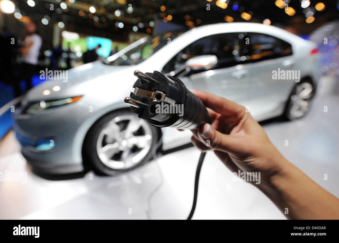 A Chevrolet / Opel Volt and its charging plug pictured ahead of the ...