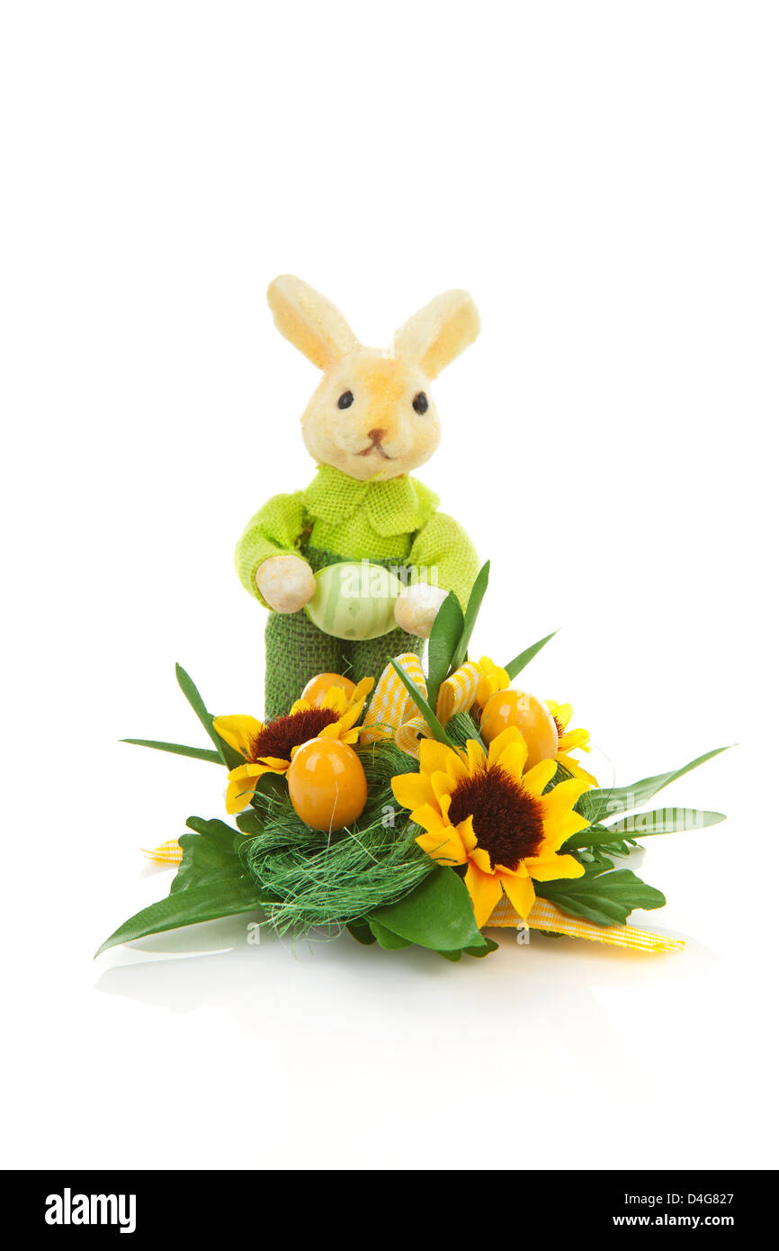 Easter arrangement with bunny, fake eggs, flowers and leaves over white ...