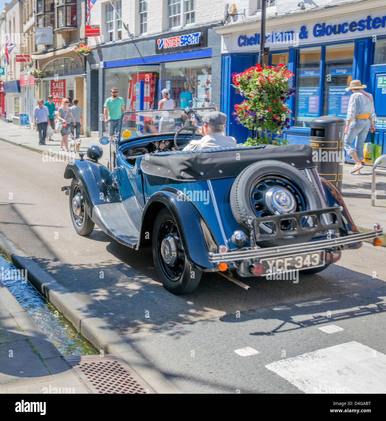 an old sports car going down a street in wells somerset Stock Photo - Alamy