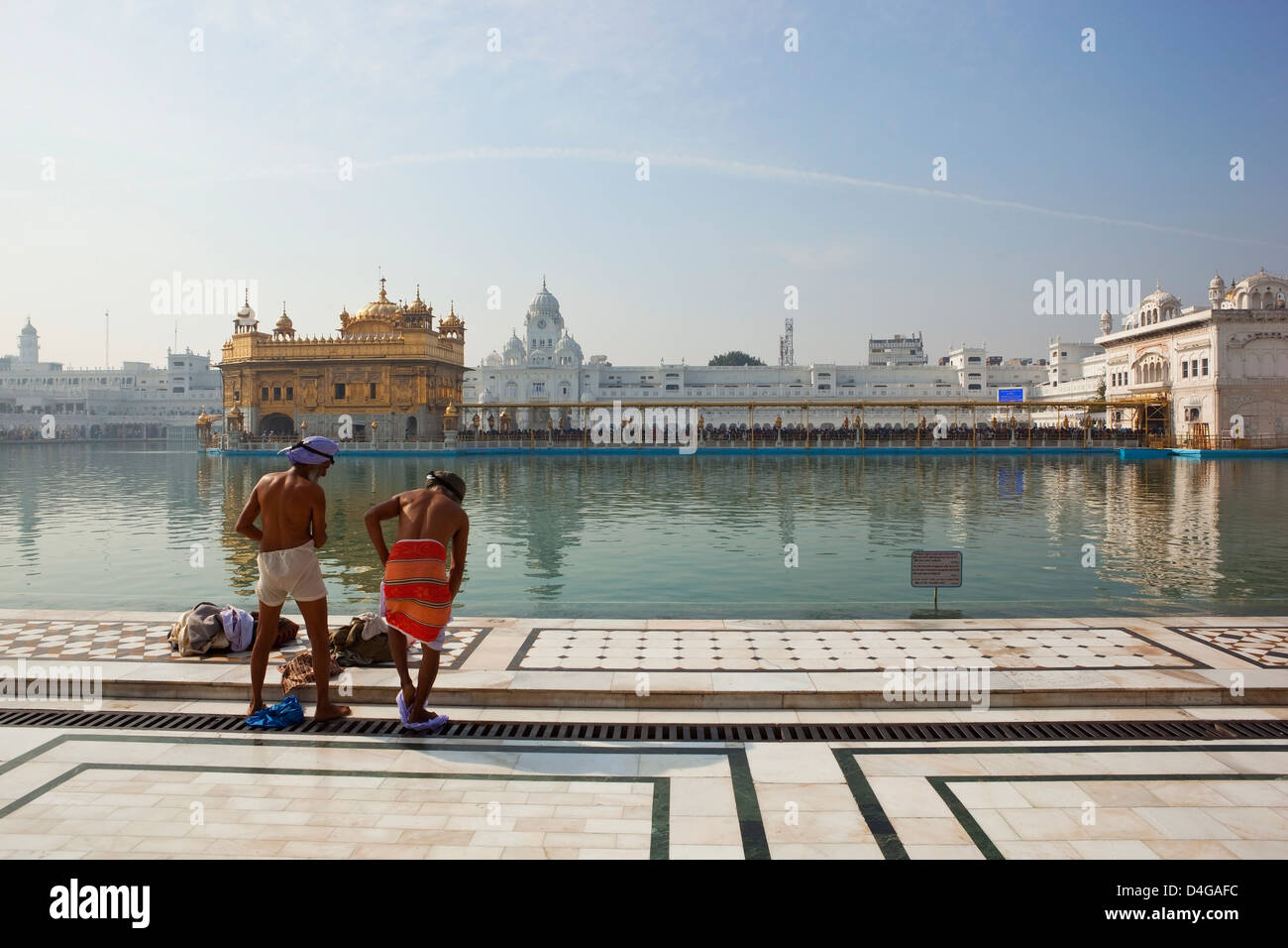 Two Sikh men at the Holy Pool inside the Golden Temple complex in ...