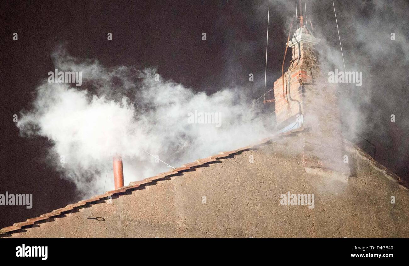 White smoke rises from the chimney of the Sistine Chapel in the Vatican ...