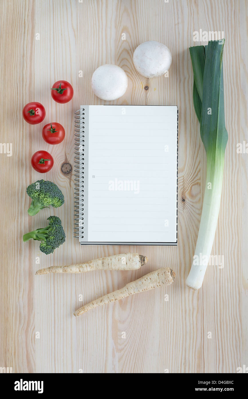 Empty notebook with vegetables on a wooden background Stock Photo - Alamy