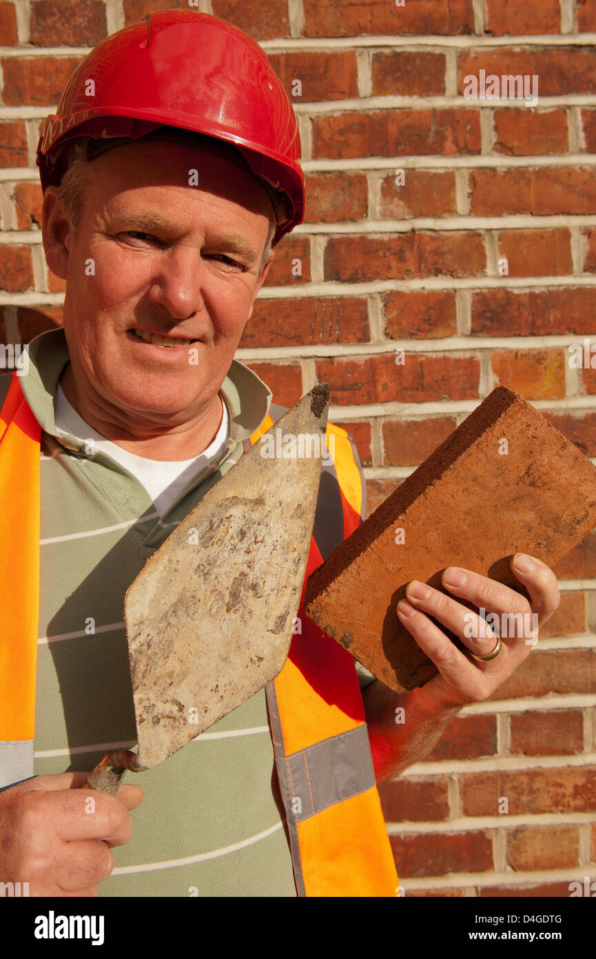 Bricklayer holding brick trowel hi-res stock photography and images - Alamy