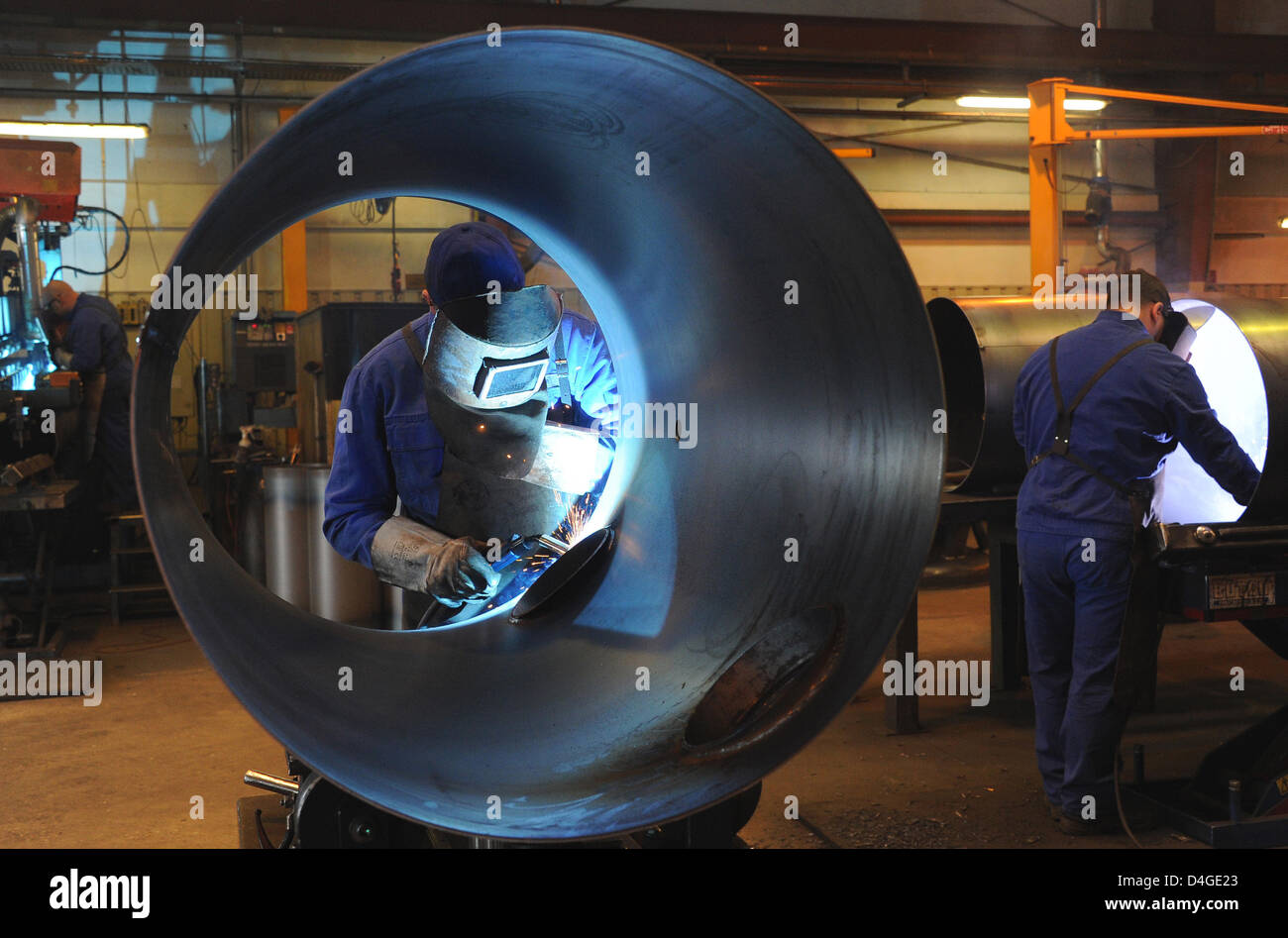 A welder works on a large metal pipe at the container manufacturer Huch ...