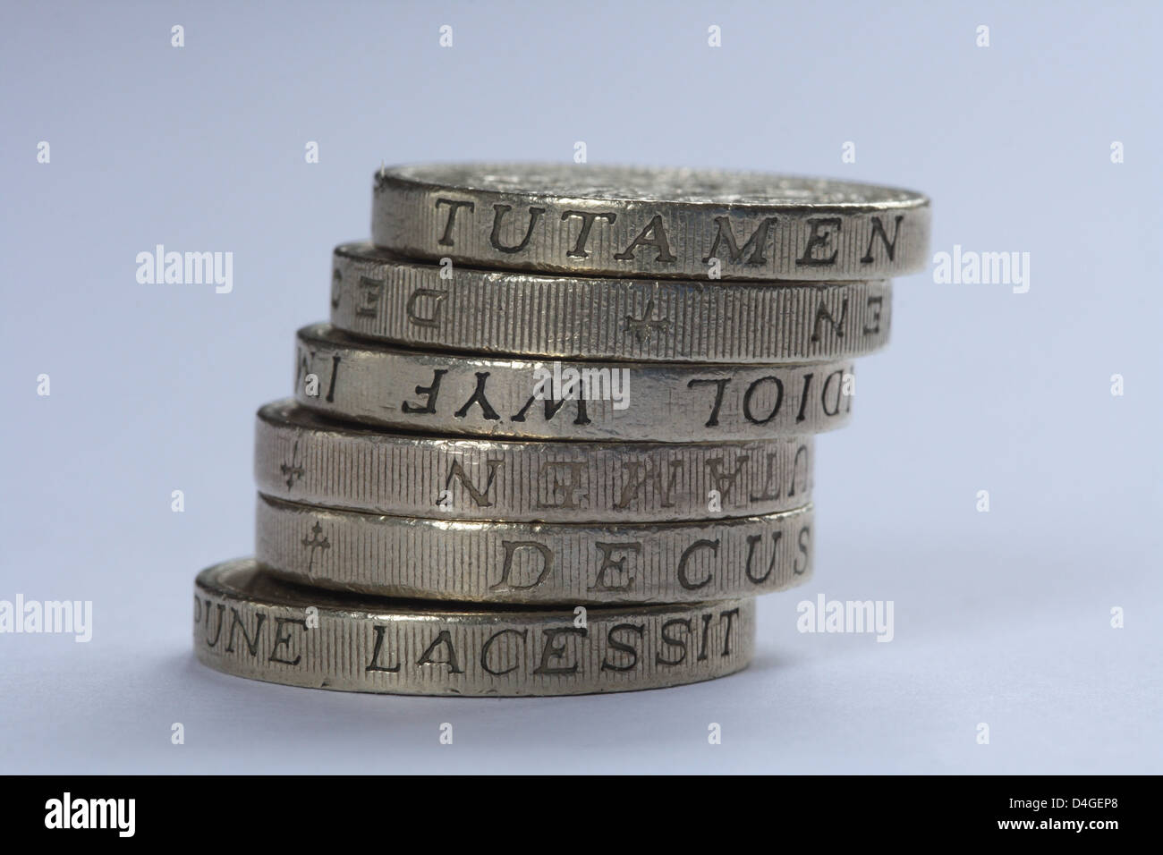 A pile of British pound coins on a pale blue background Stock Photo - Alamy